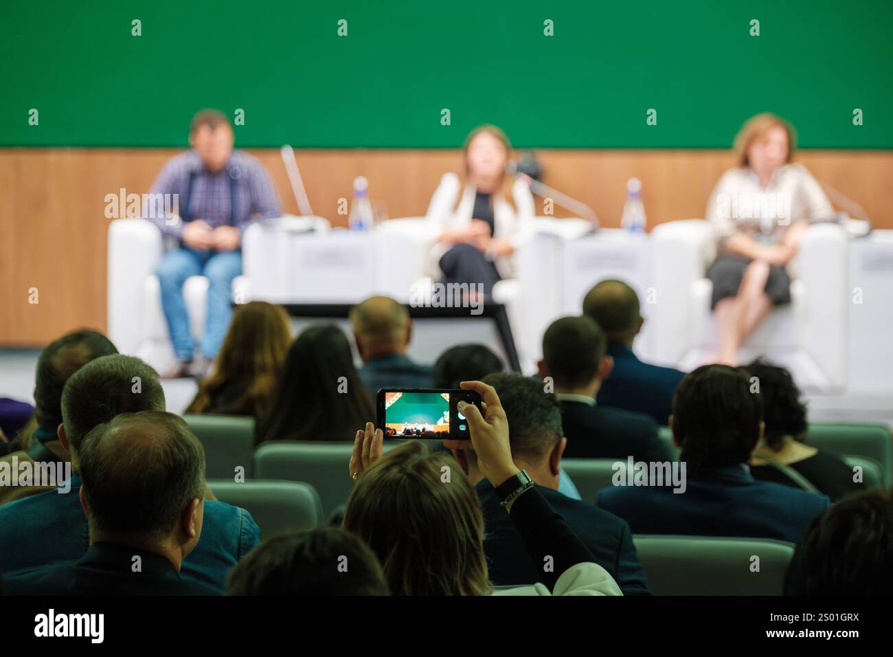 Business conference with group of people attending panel discussion and ...