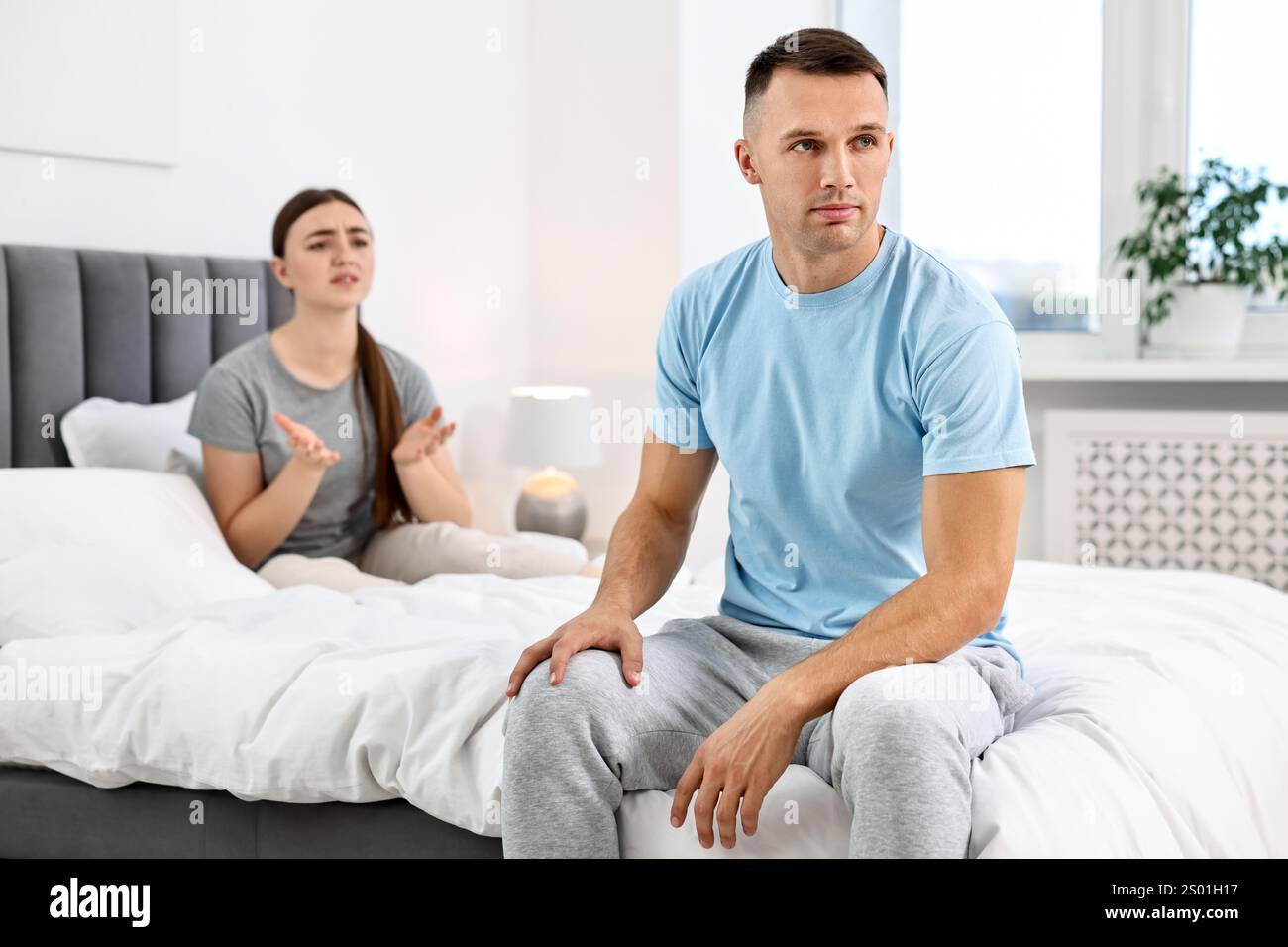 Wife apologizing her husband while he ignoring her in bedroom ...