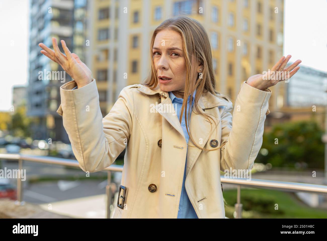 Doubtful frustrated mature businesswoman shrugging shoulders dont know ...