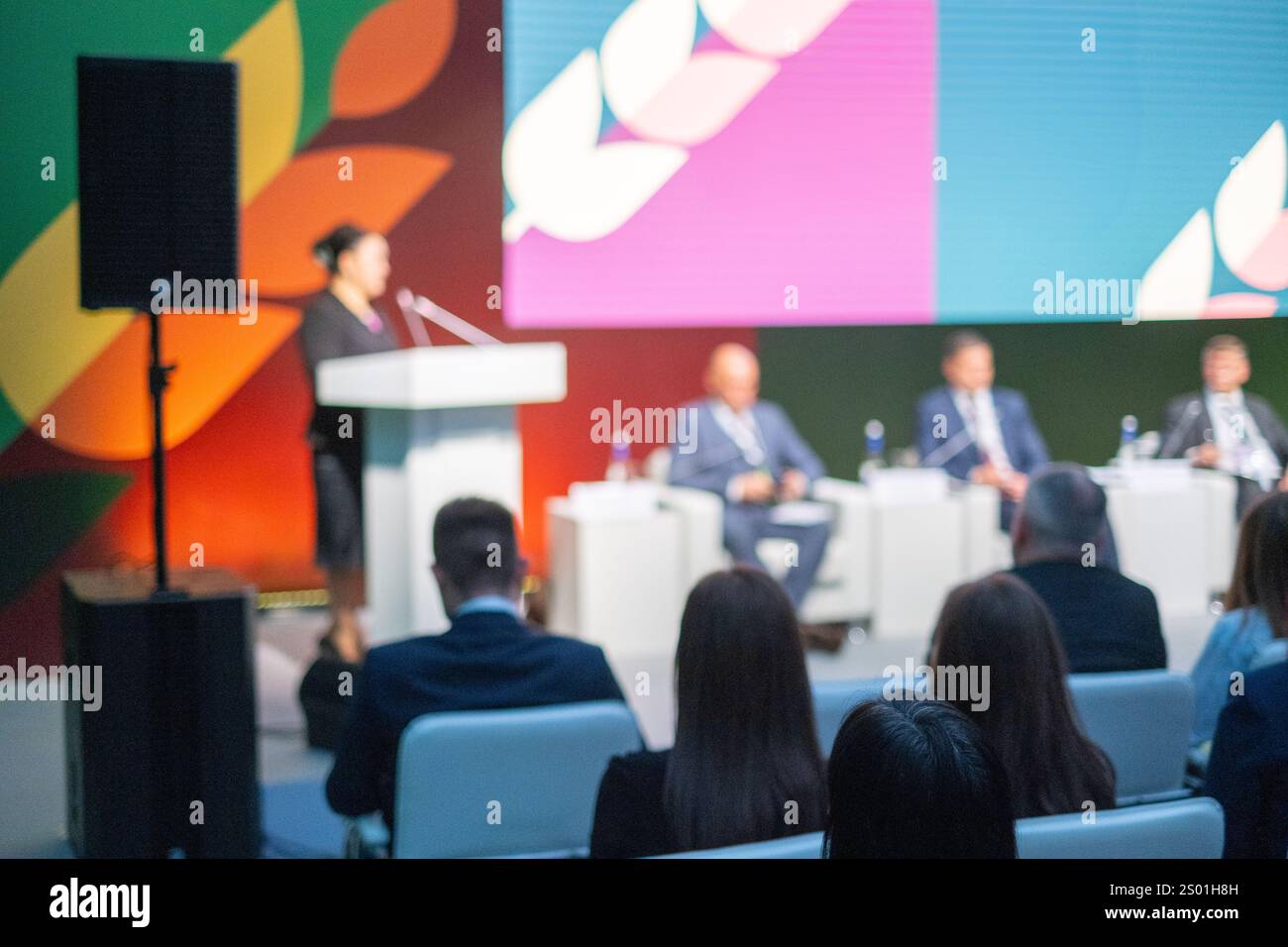 Blurry background of business presentation with people attending ...