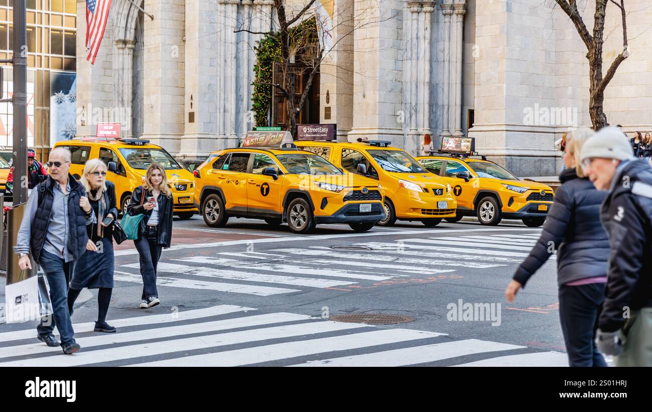 New York, Manhattan, USA - February 15, 2023: Yellow cab taxis driving ...