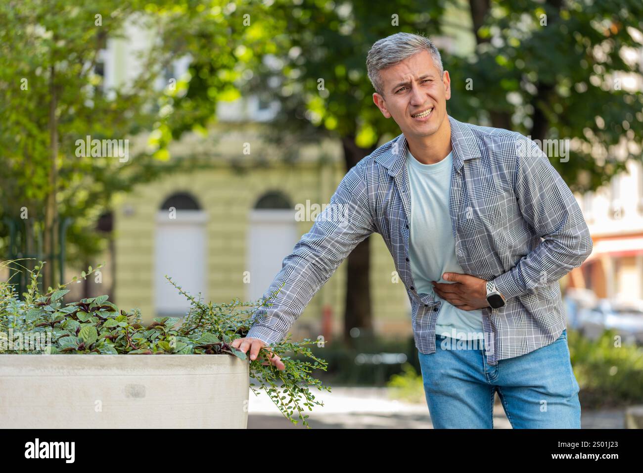 Caucasian mature man traveler feeling sudden strong abdominal stomach ...
