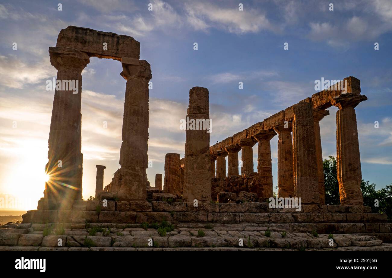 Ancient ruins with tall columns against a sunset sky, showcasing ...