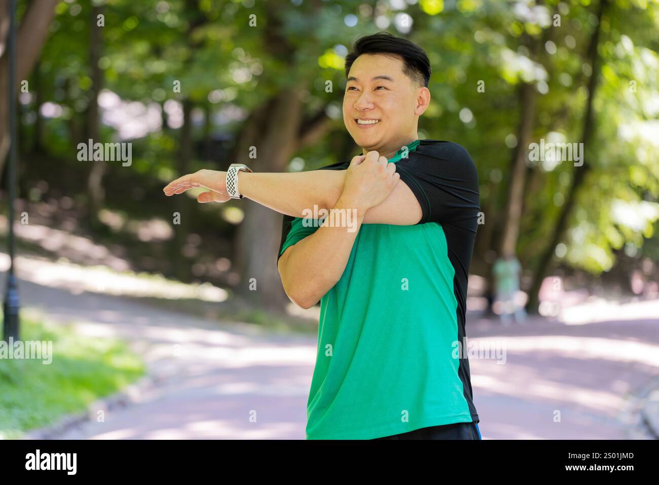 Japanese sporty man athlete healthy guy in park outdoors in city forest ...