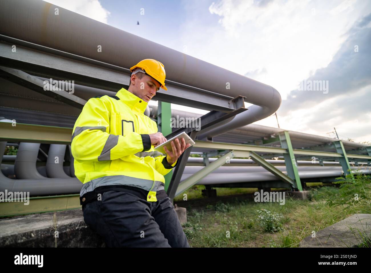 A construction worker in bright yellow safety gear is checking ...