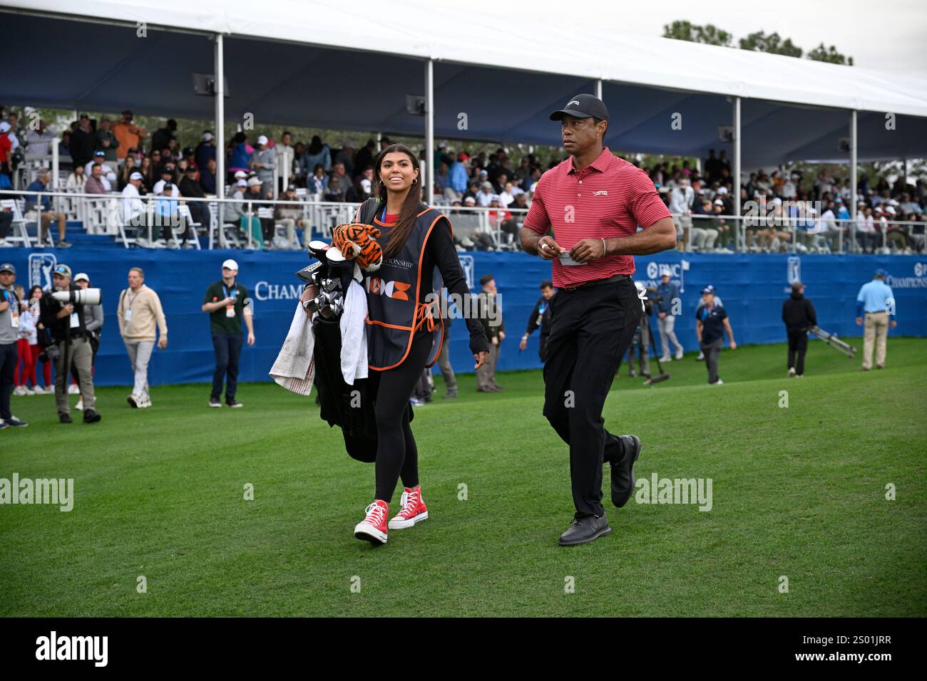 Tiger Woods, right, leaves the 18th green with his daughter Sam Woods ...