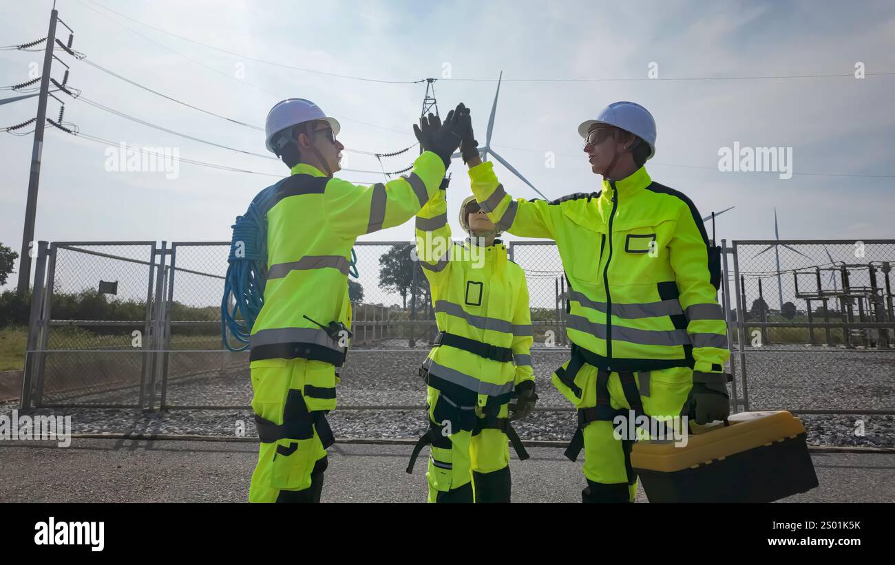 Three construction workers in high-visibility safety gear celebrate a ...