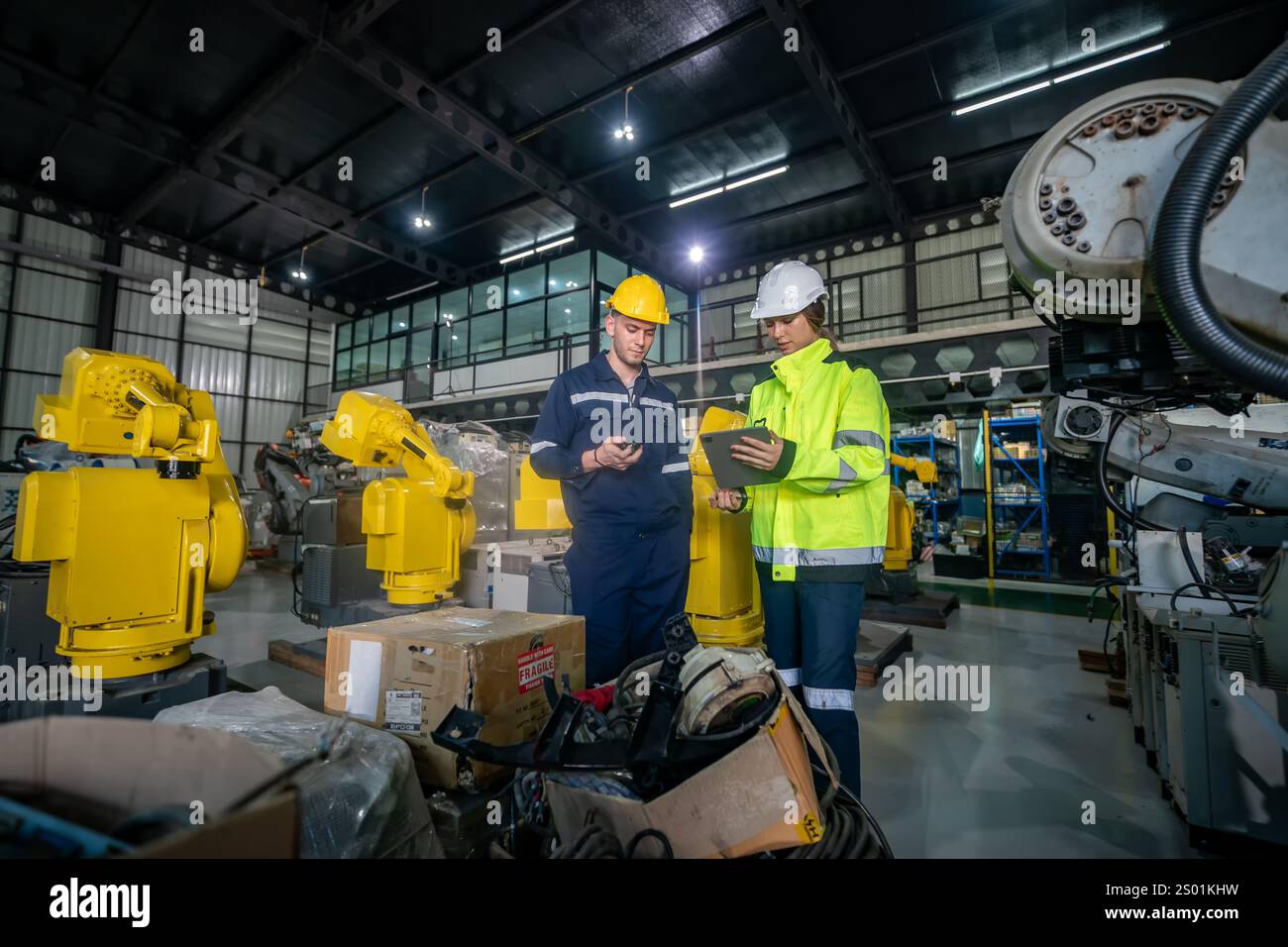 Two engineers are discussing technical details in an industrial space ...