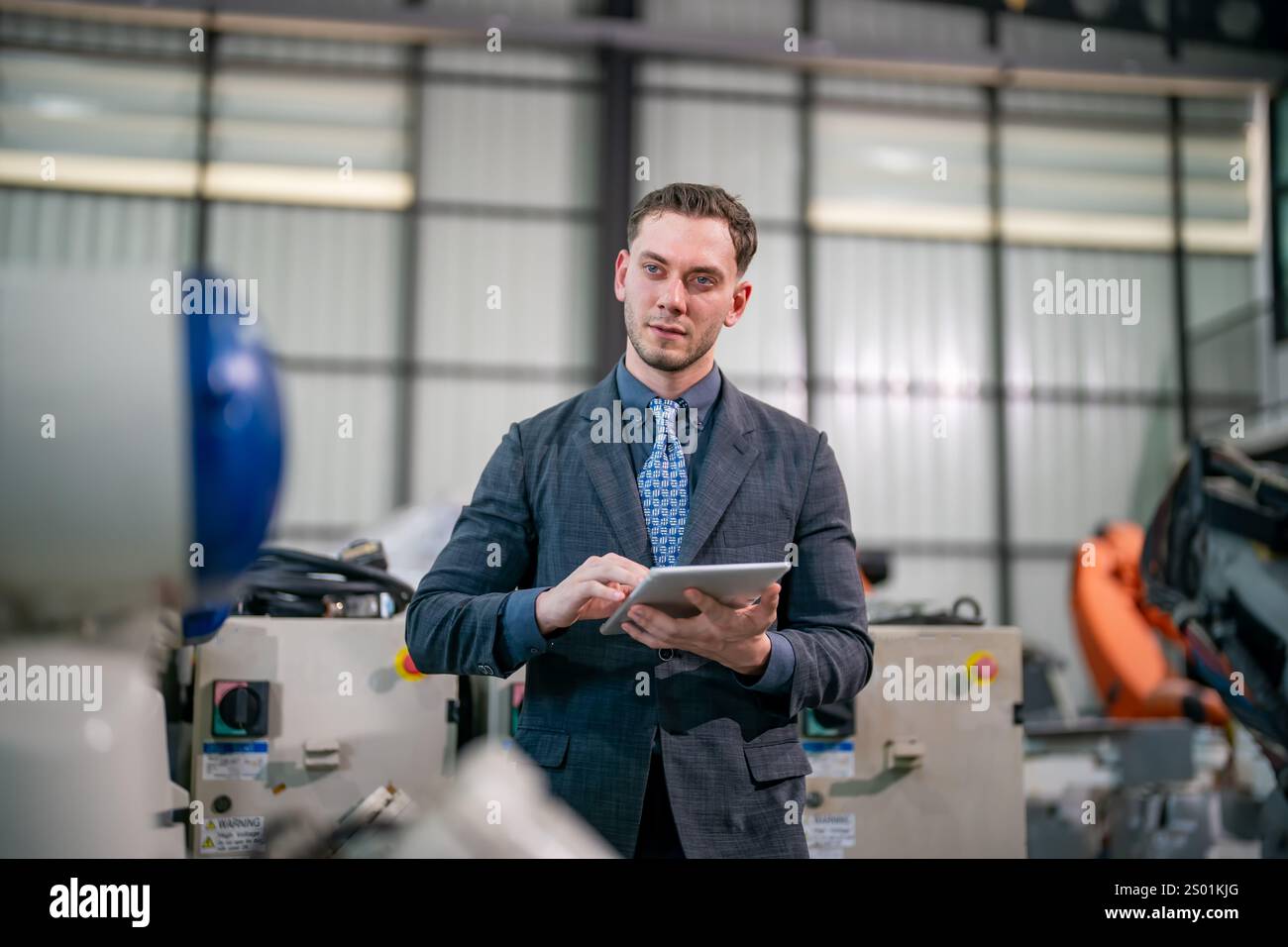 An aerial view captures a professional assessing industrial equipment ...