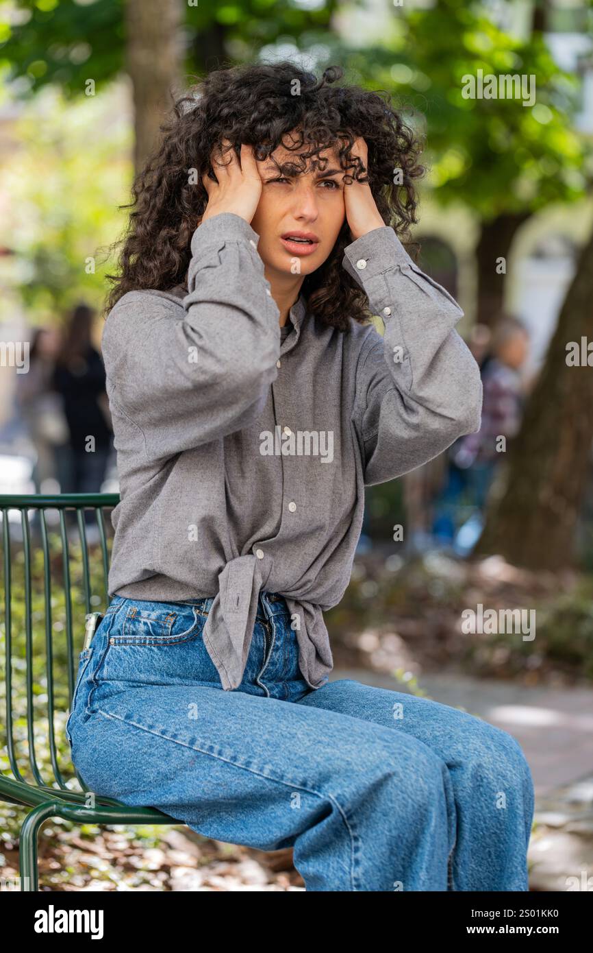 Displeased exhausted young woman rubbing temples to cure headache ...