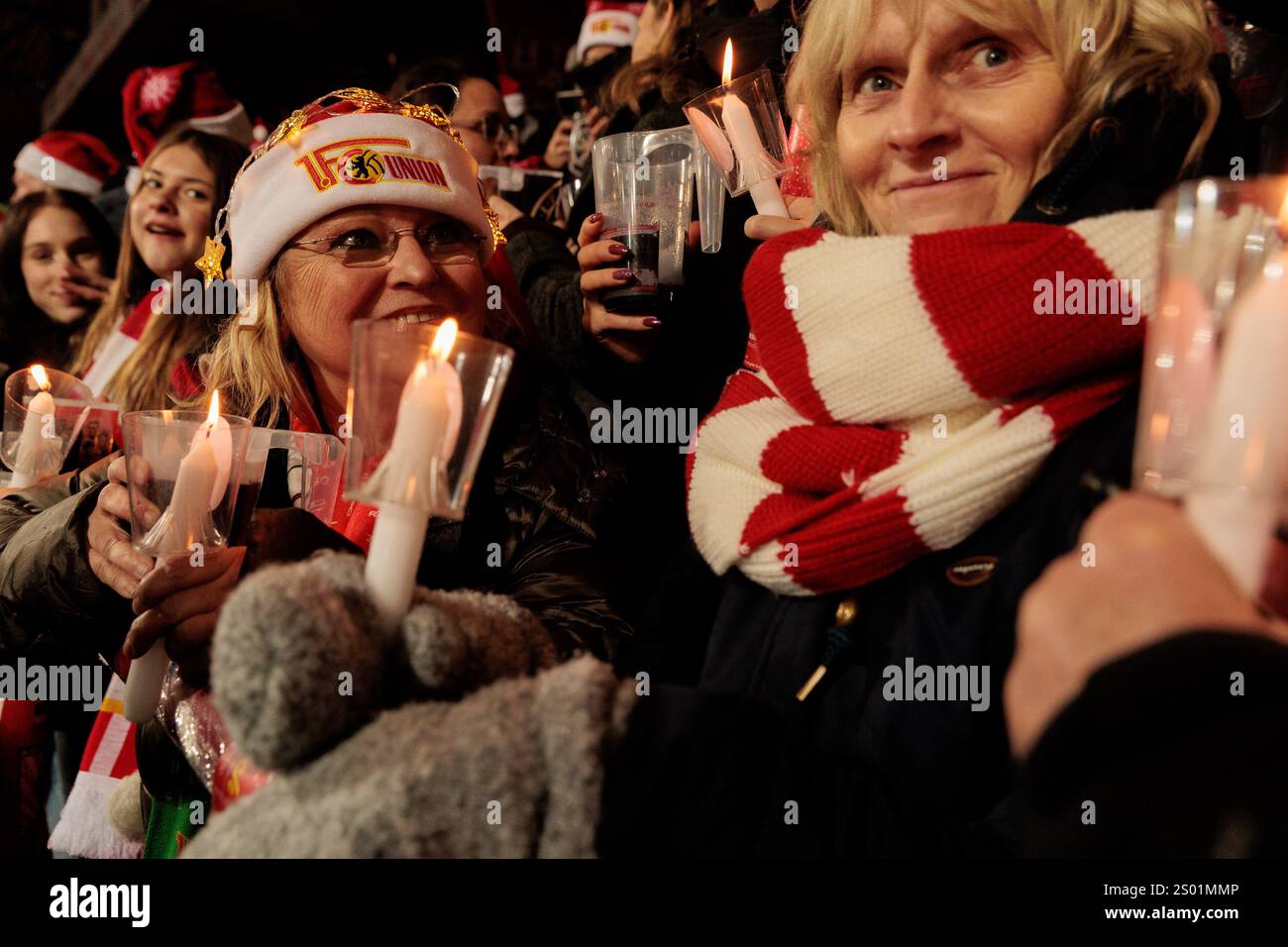 Berlin, Germany. 23rd Dec, 2024. Fans carry candles during the ...