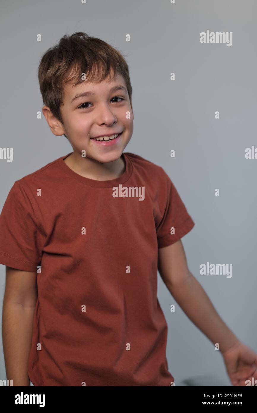 A boy smiles warmly, capturing a moment of joy and friendliness. The ...
