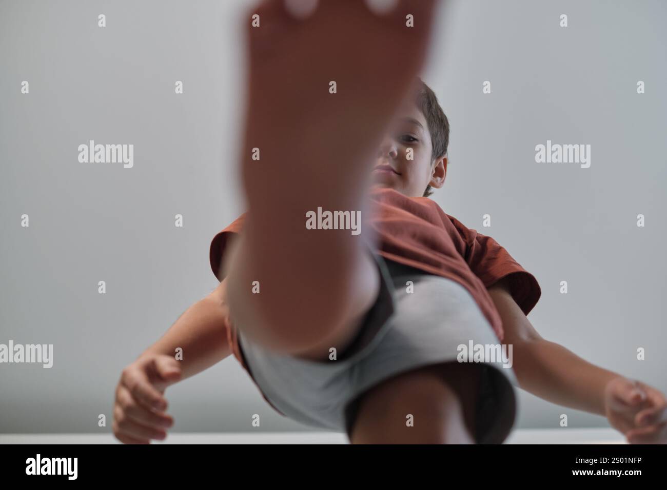 A child steps forward with one foot close to the camera, captured from ...