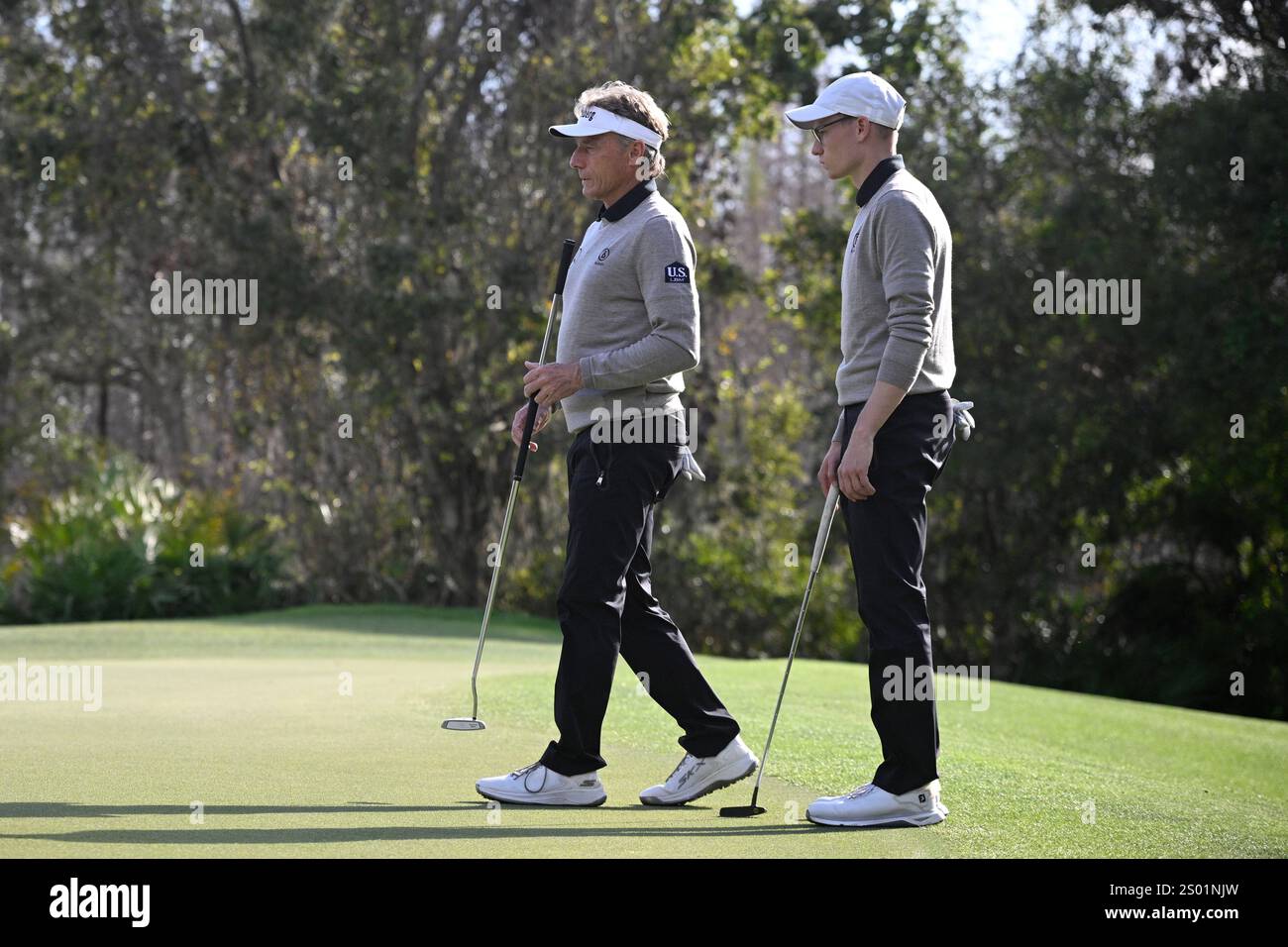 Bernhard Langer, left, and his son Jason Langer, line up a putt on the ...