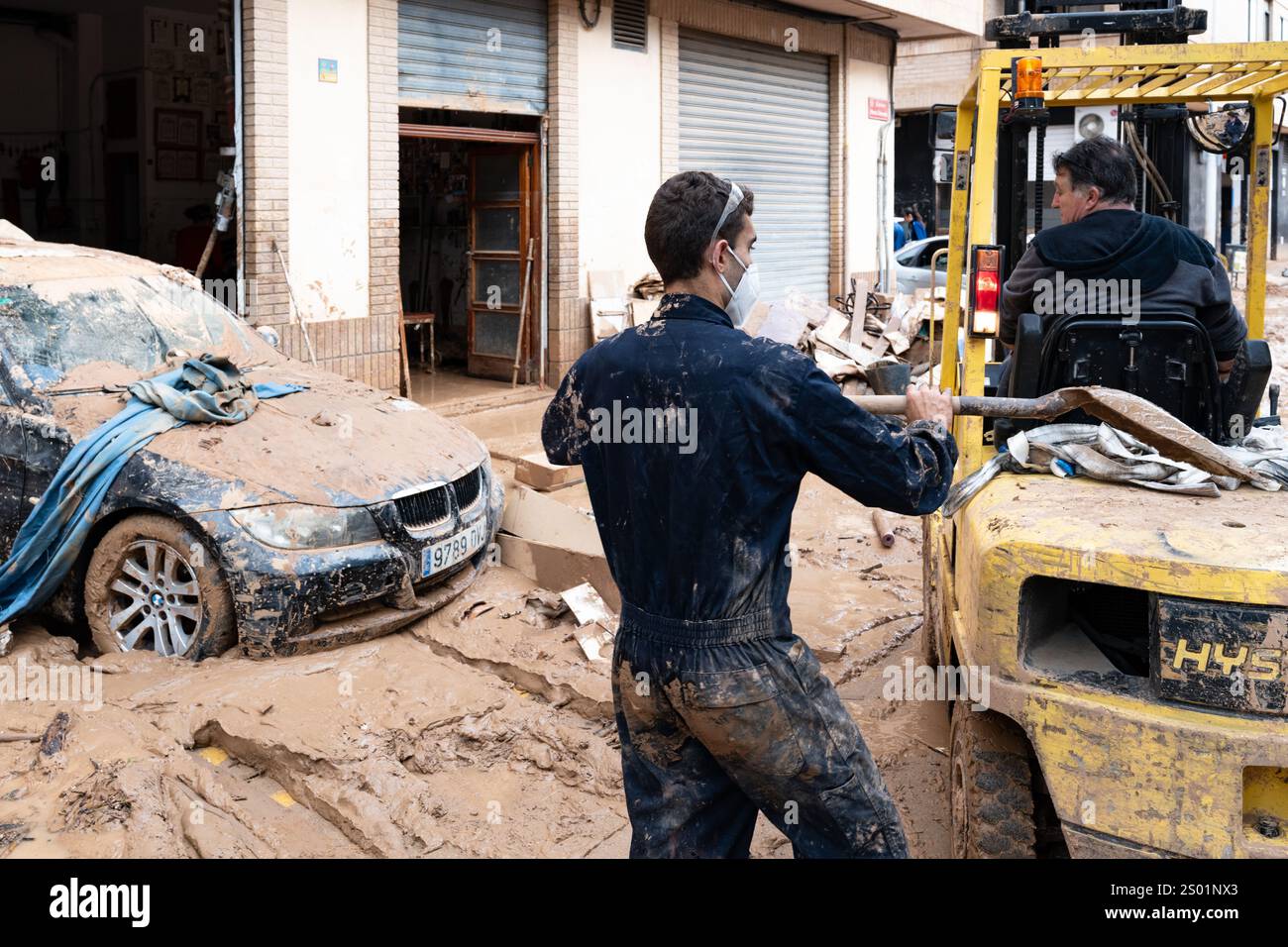DANA flooding effects. Flood impacts, Valencia, Spain. Volunteers and ...