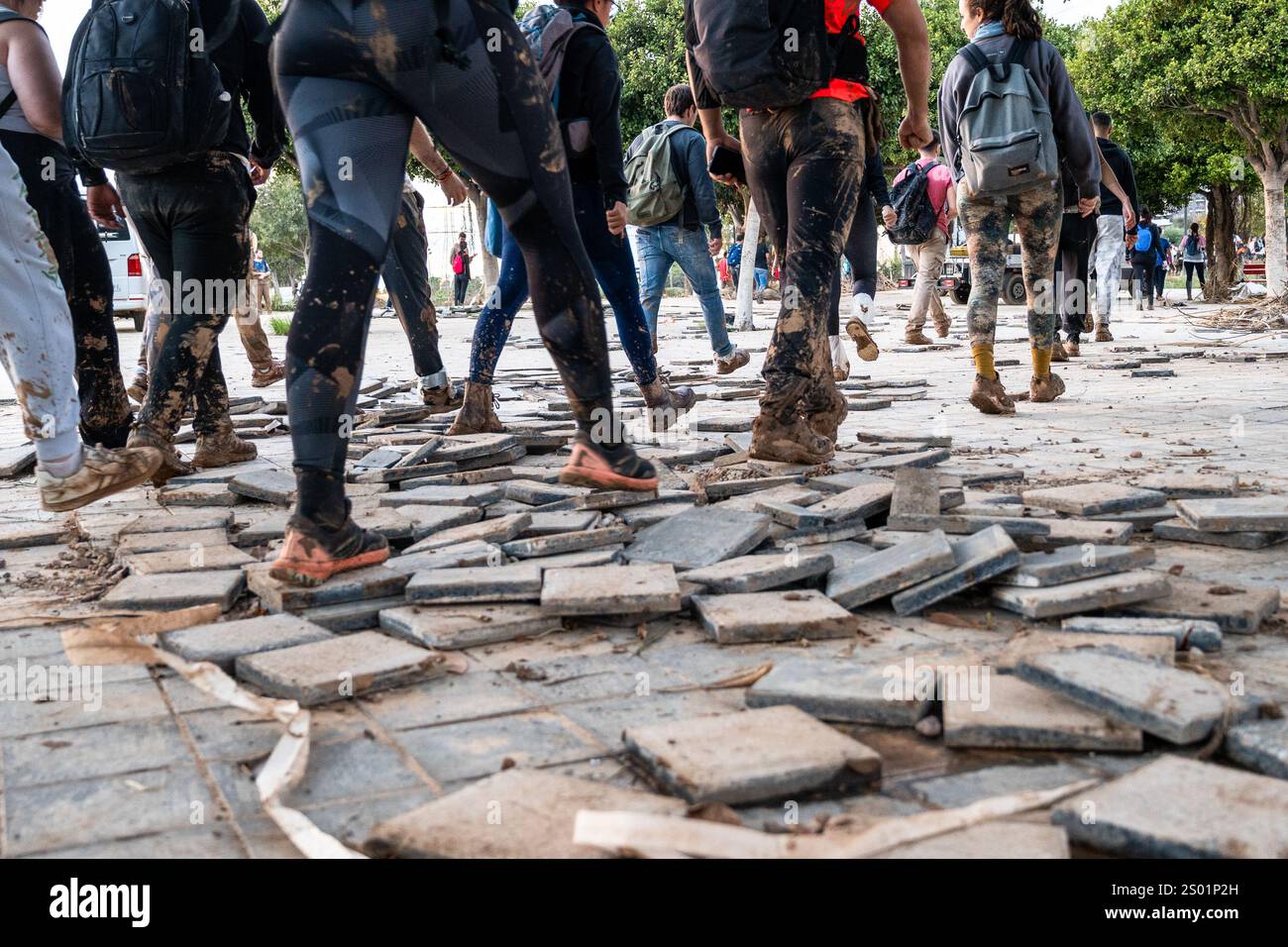 DANA flooding effects. Flood impacts, Valencia, Spain. Volunteers legs ...