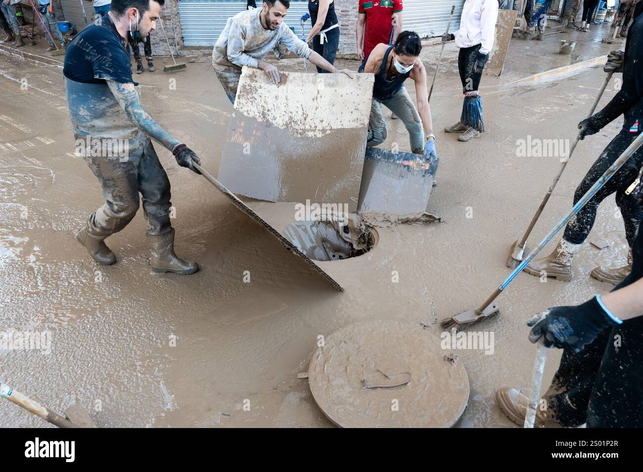 DANA flooding effects. Flood impacts, Valencia, Spain. Volunteers and ...
