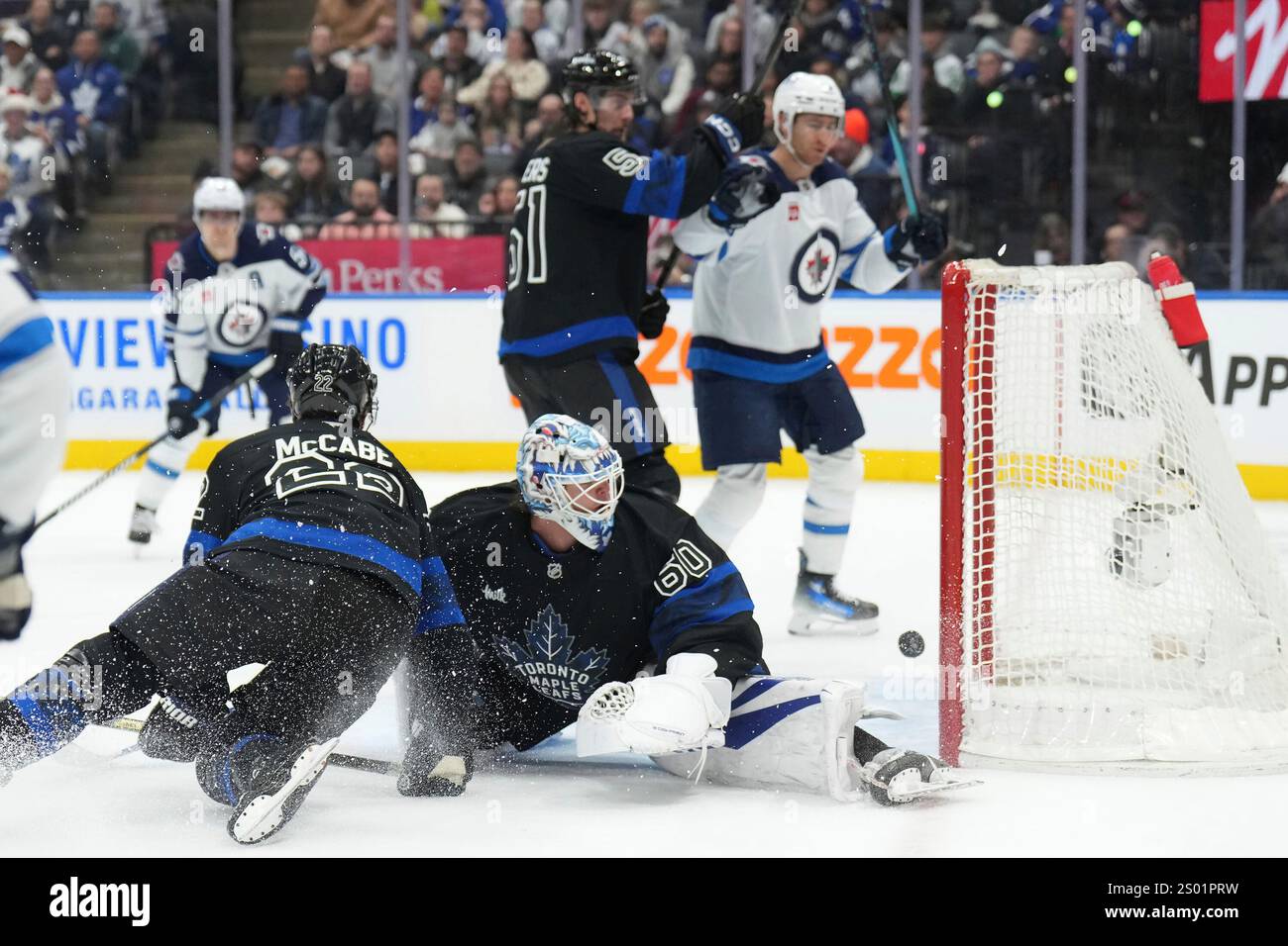 Toronto Maple Leafs goaltender Joseph Woll (60) looks back as Winnipeg ...