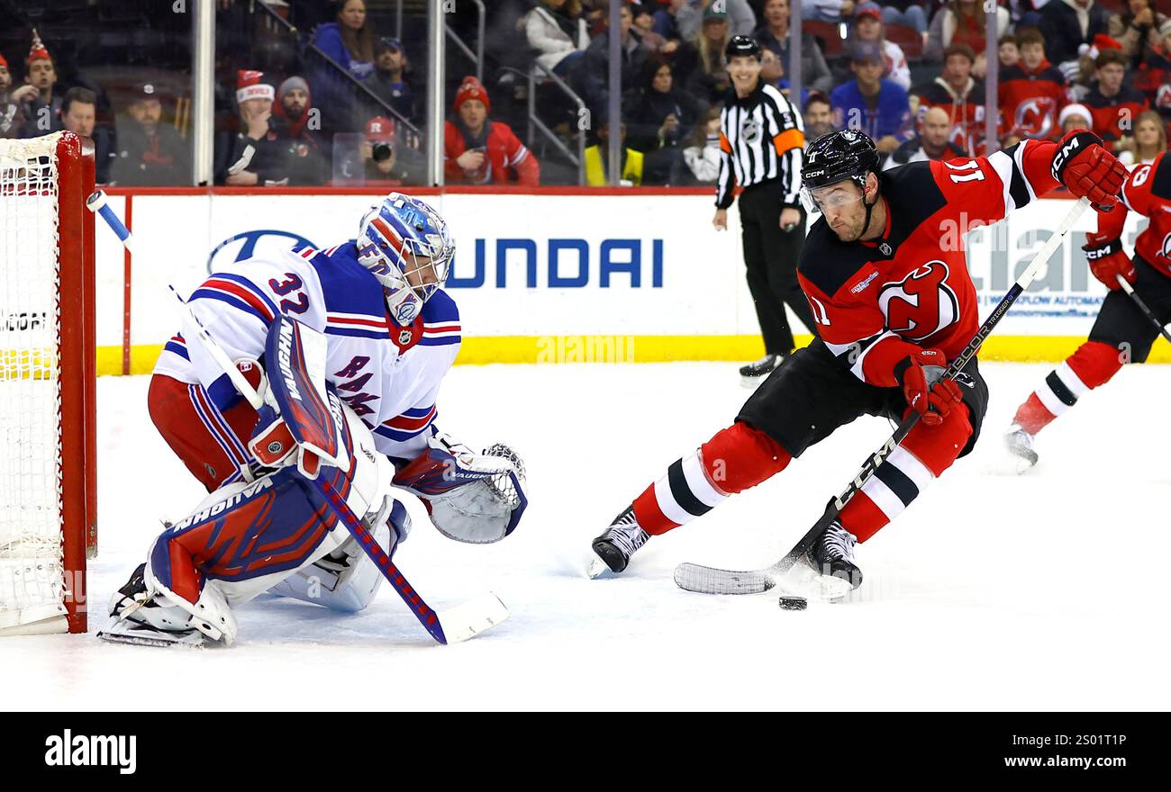 New Jersey Devils right wing Stefan Noesen (11) plays the puck in front ...