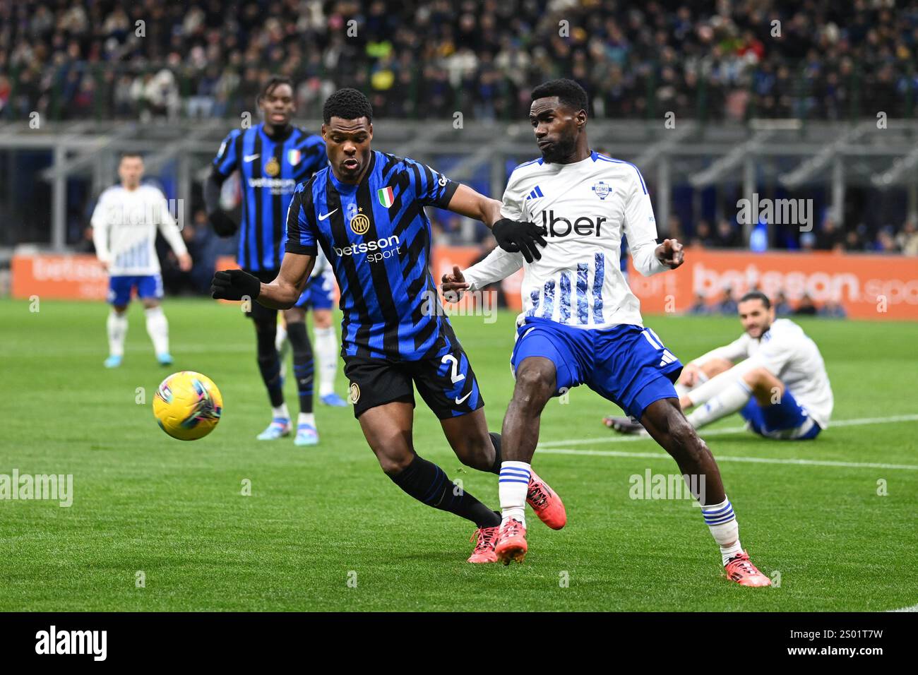 Milan, Italy. 23rd Dec, 2024. Denzel Dumfries (Inter) and Alieu FADERA ...