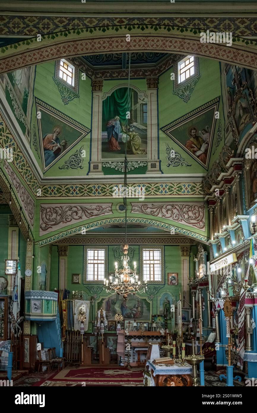 The inside of a church is decorated with green and gold colors. The ...