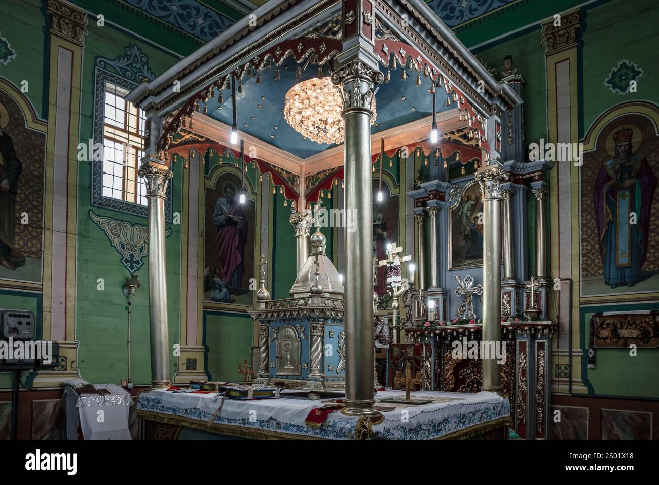 A church with a gold and green color scheme. The altar is decorated ...
