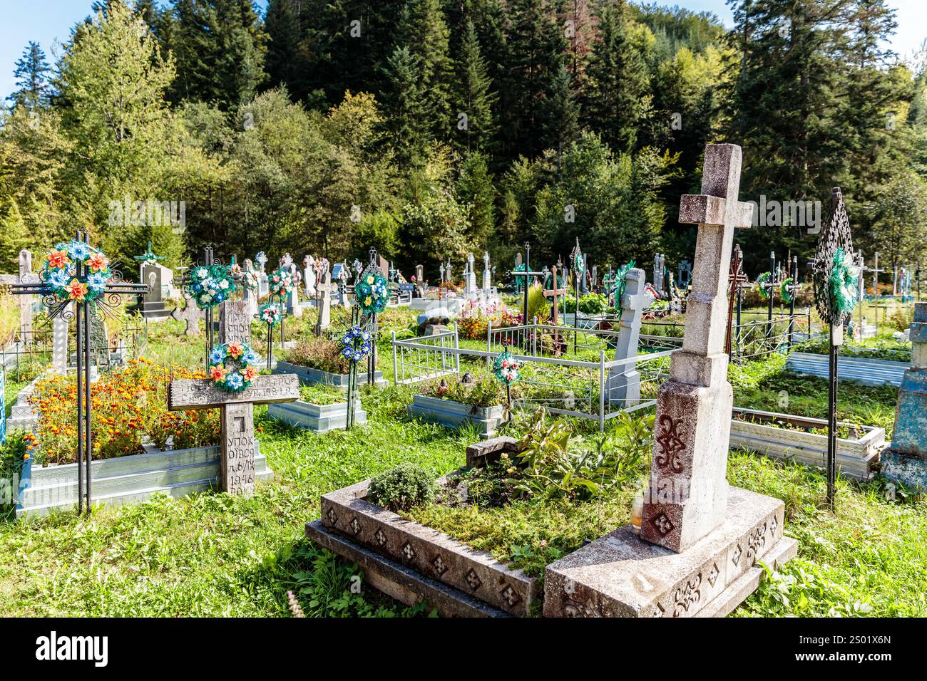 A cemetery with many graves and a cross. The cemetery is full of ...