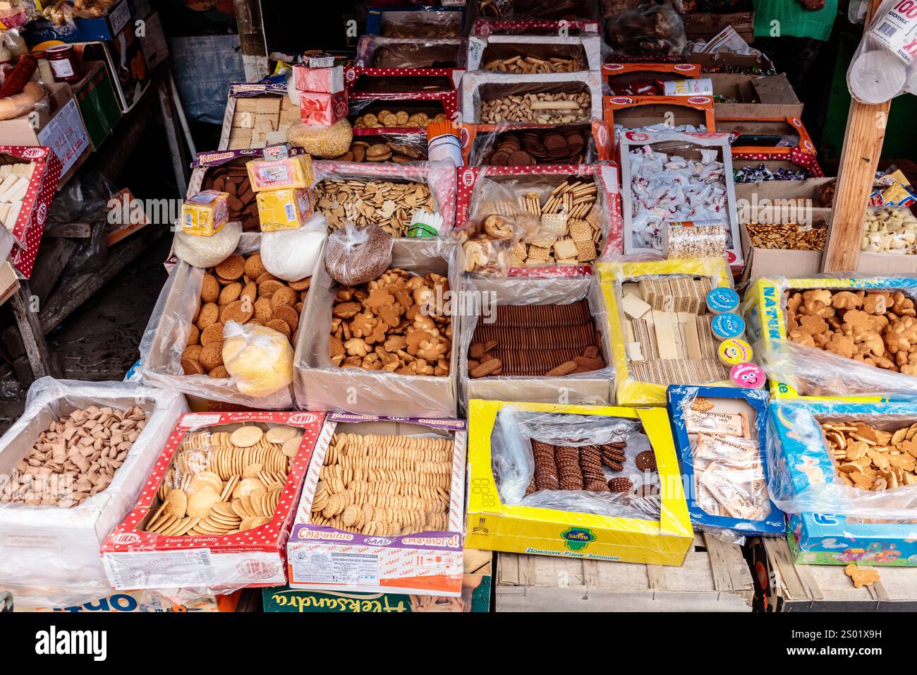 A variety of cookies and other snacks are displayed in boxes and bags ...