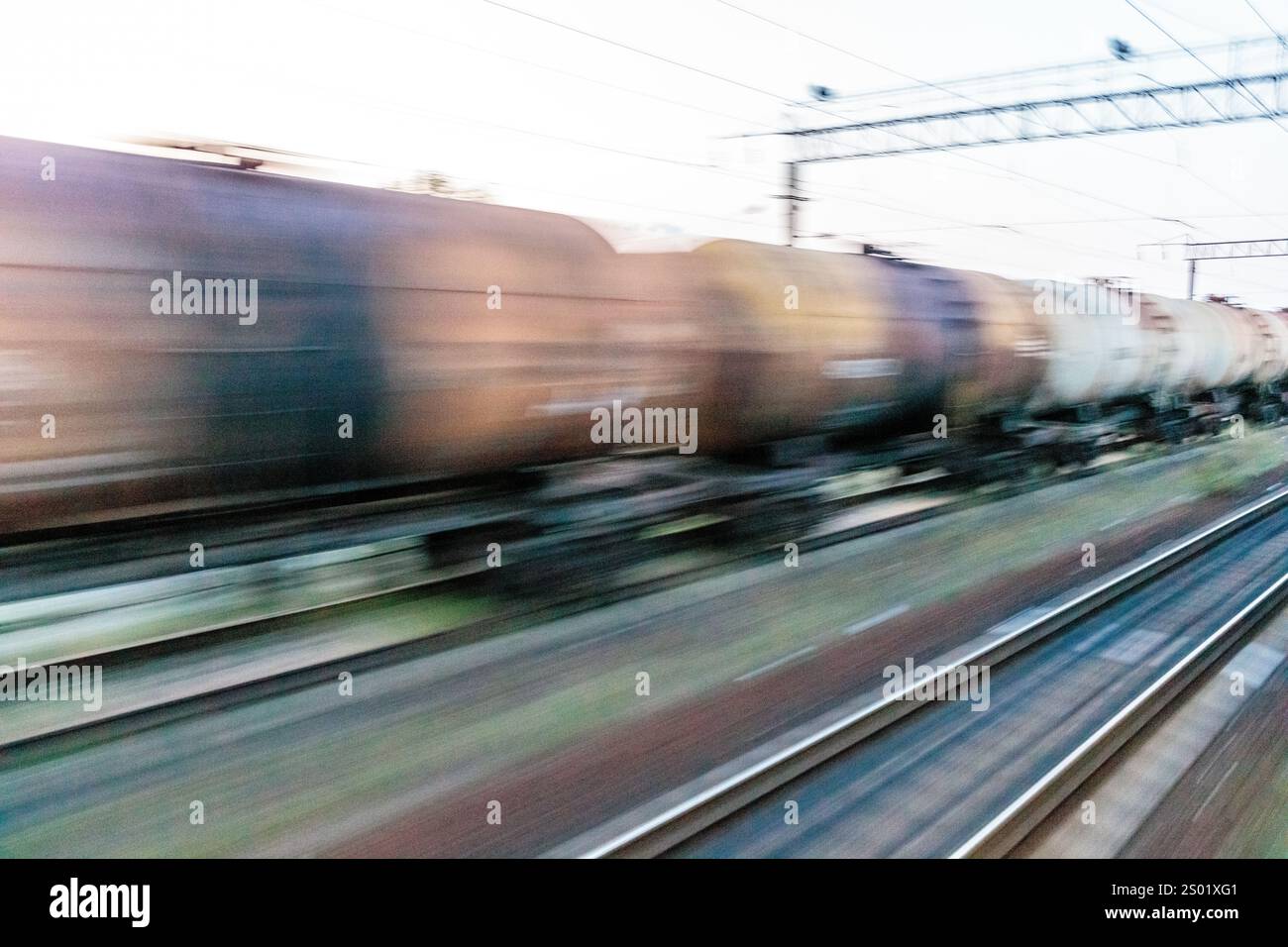 A train is moving down the tracks with a blurry background. The train ...