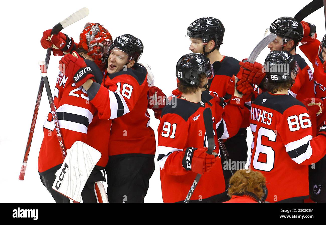 New Jersey Devils goaltender Jacob Markstrom (25) receives as hug from ...