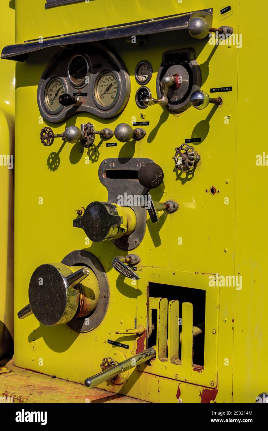 A yellow machine with a lot of knobs and dials. The dials are old and ...