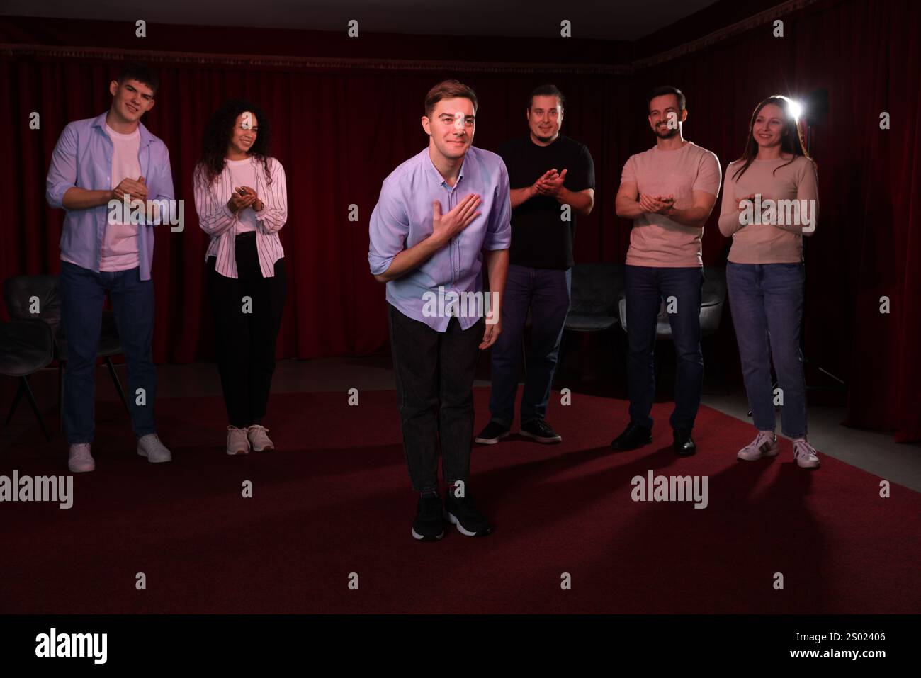 Professional actors bowing on stage in theatre Stock Photo - Alamy