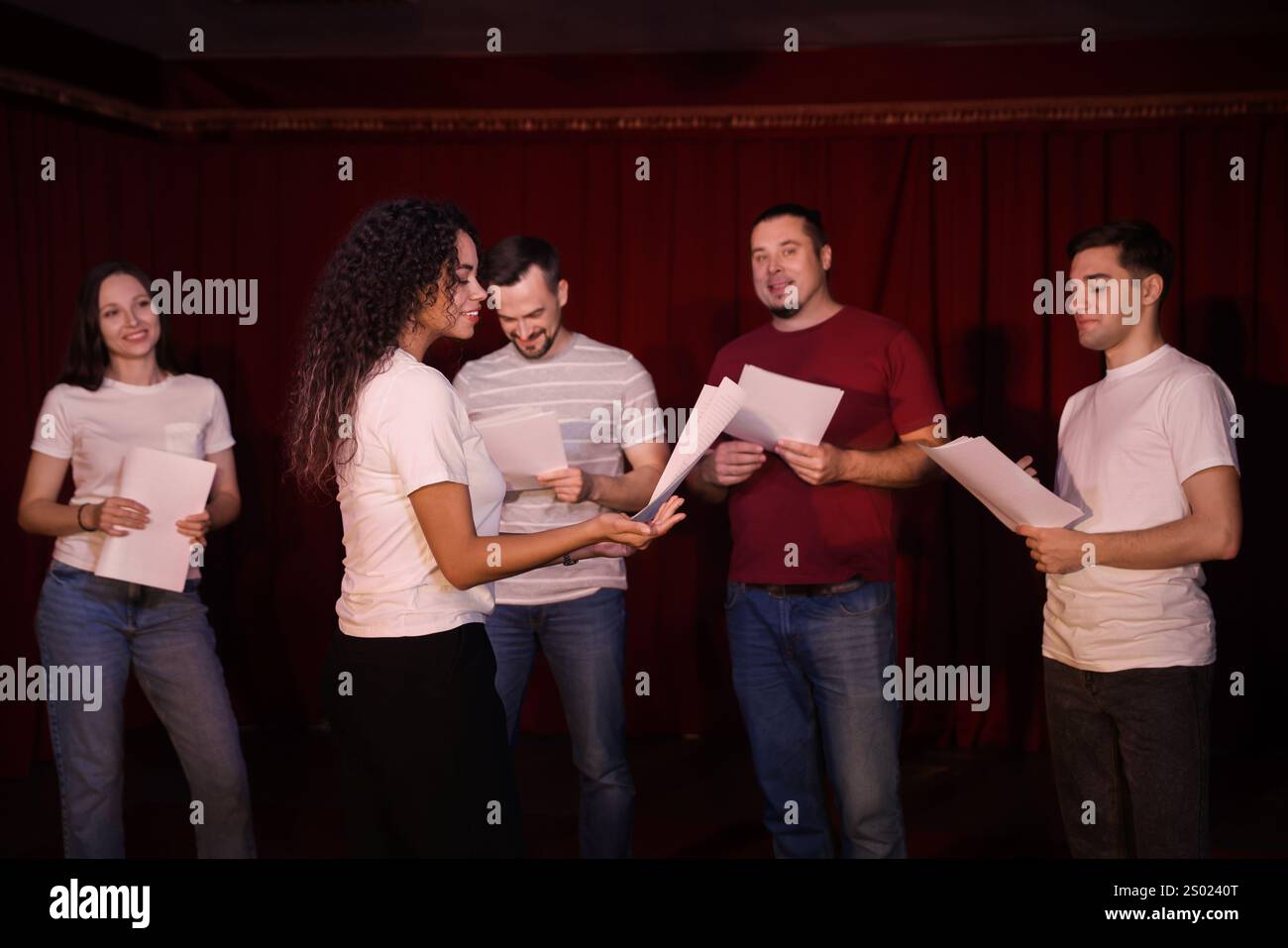 Professional actors with their scripts rehearsing in theatre Stock ...