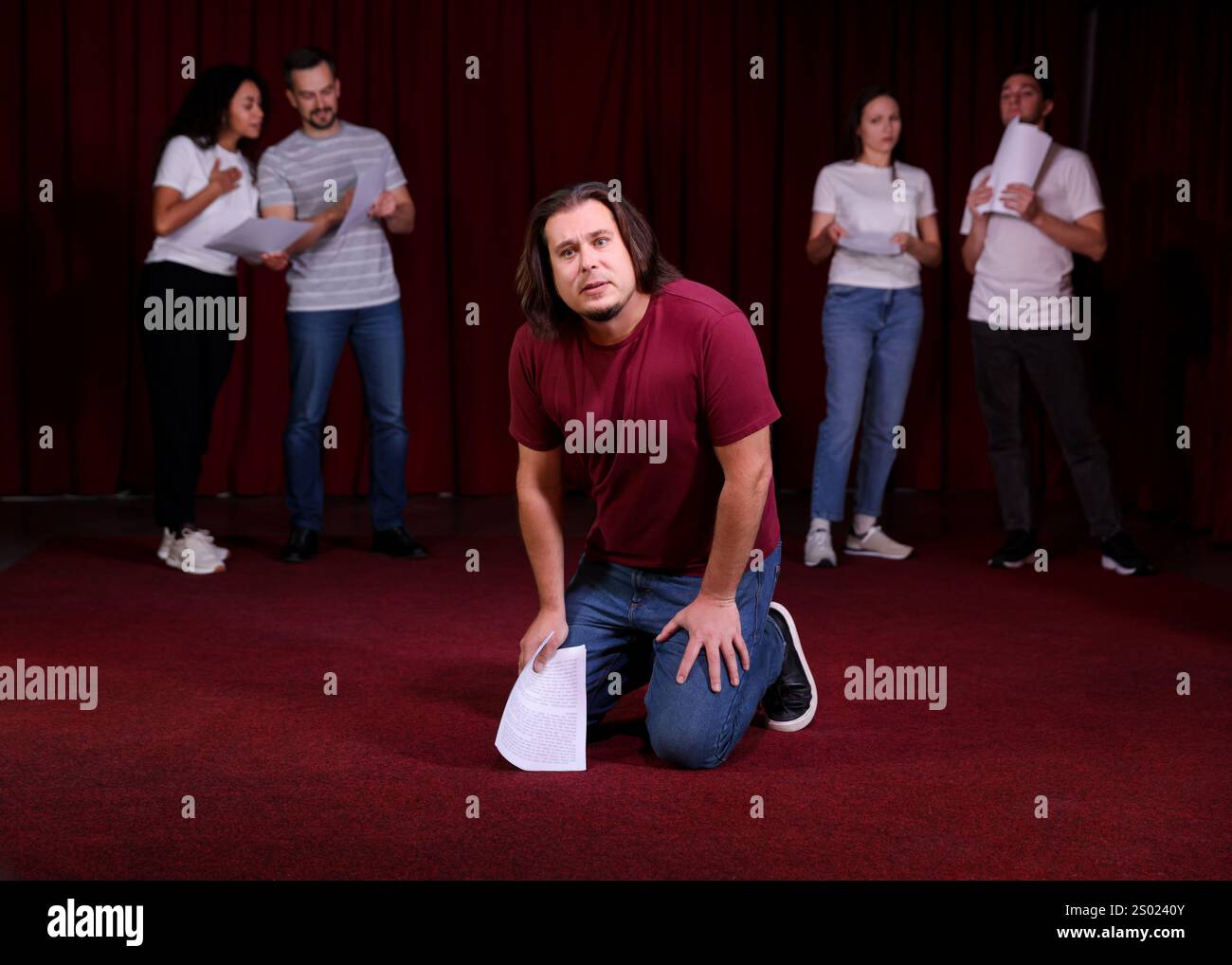 Professional actors with their scripts rehearsing in theatre Stock ...