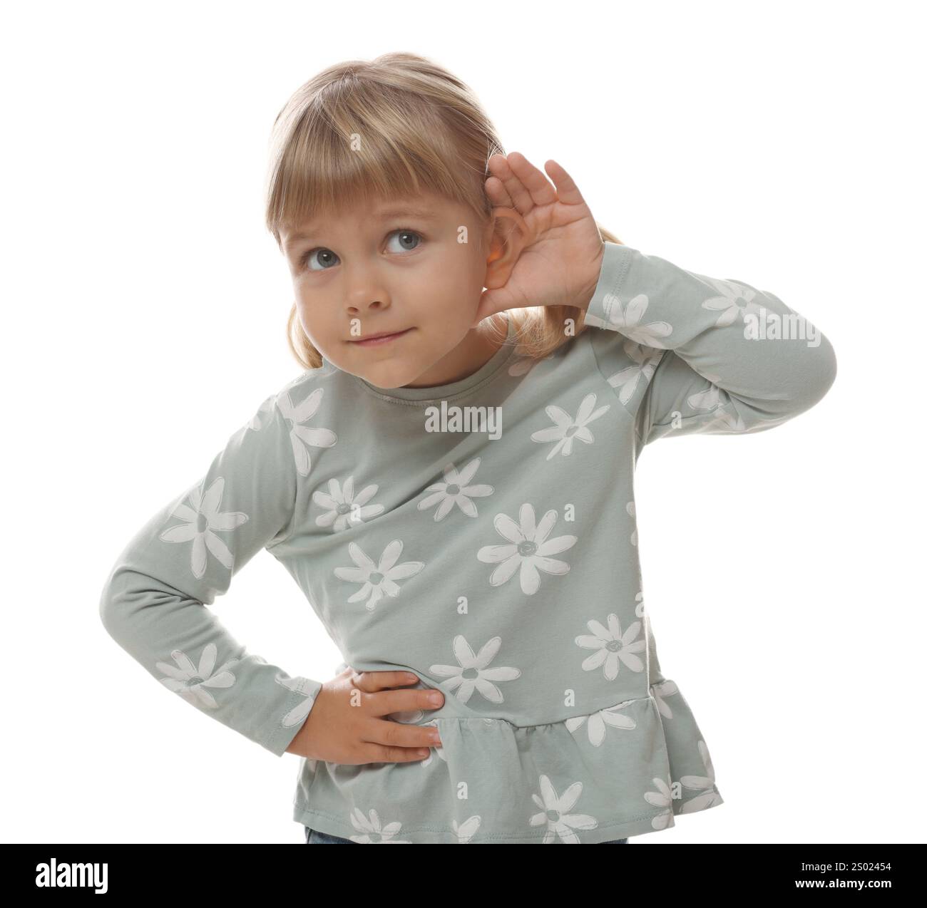 Little girl showing hand to ear gesture on white background Stock Photo ...
