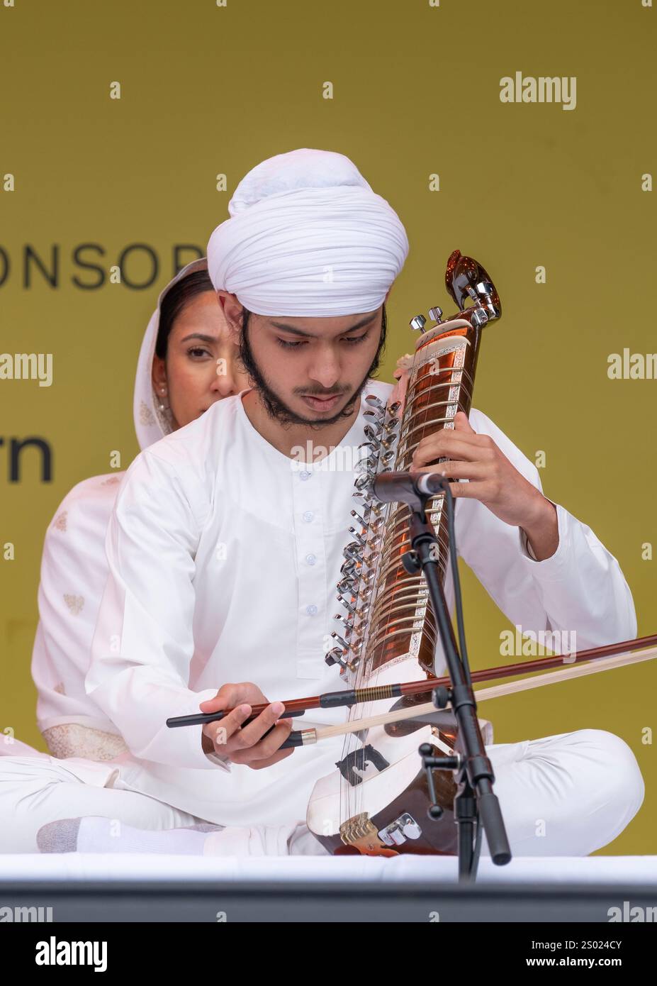 Sikh musician performing on the dilruba at the Vaisakhi Festival in ...