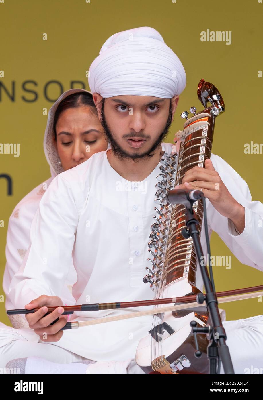 Sikh musician performing on the dilruba at the Vaisakhi Festival in ...