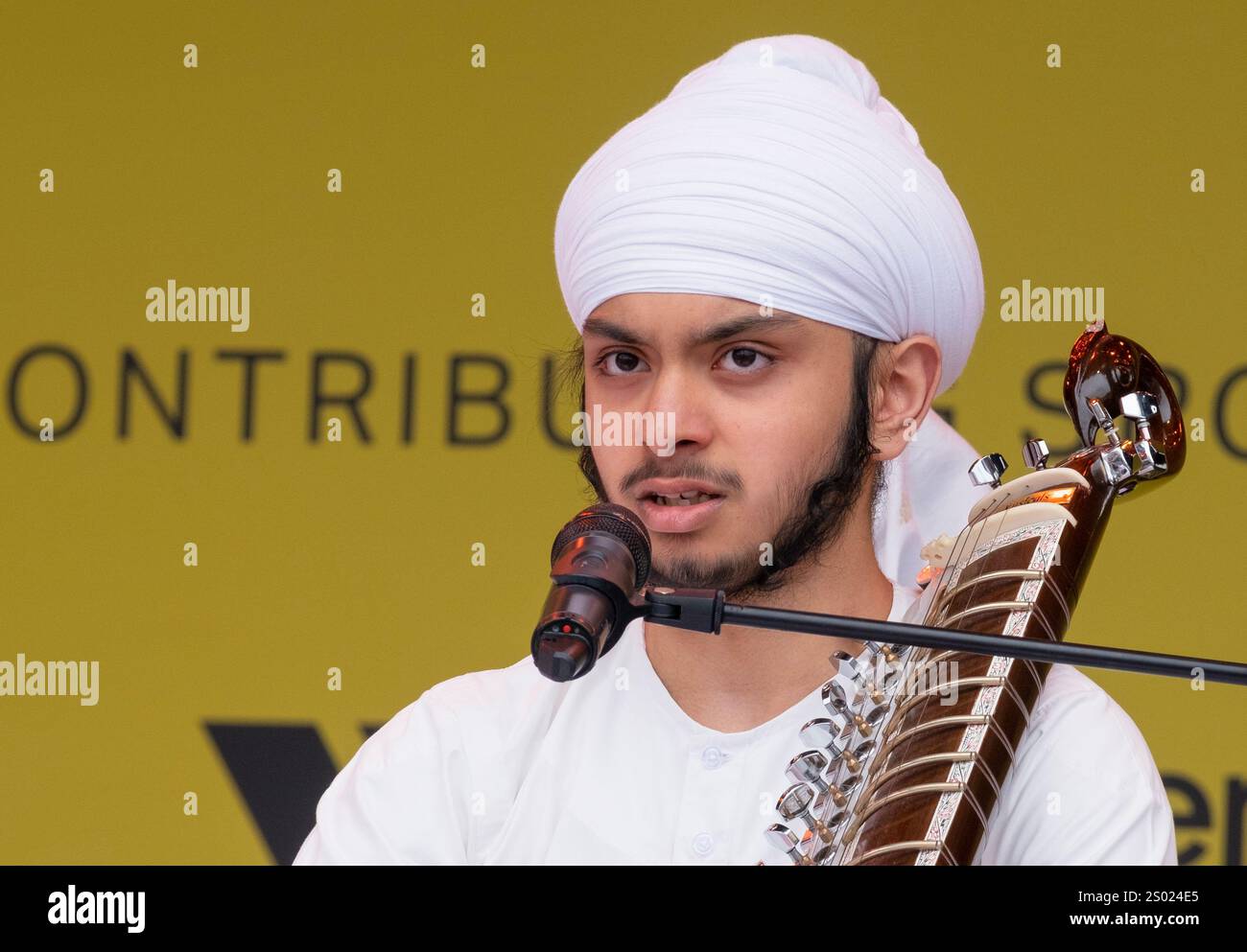 Sikh musician performing on the dilruba at the Vaisakhi Festival in ...