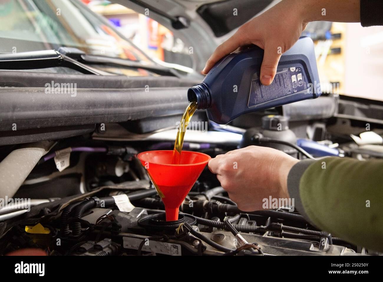 Auto mechanic work on oil change in BMW Stock Photo - Alamy
