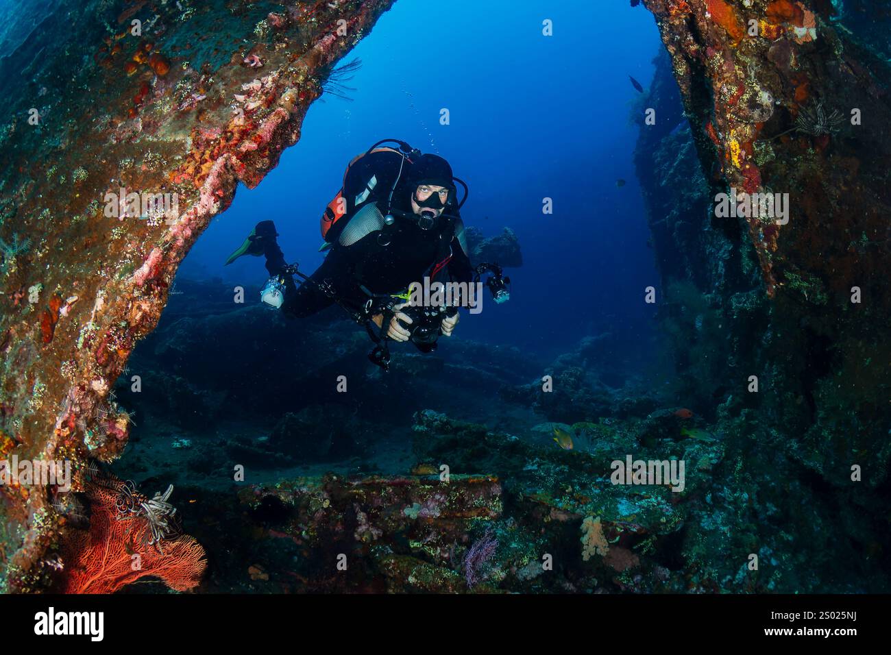 Underwater photographer on the ww2 shipwreck USAF Liberty at Tulamben ...