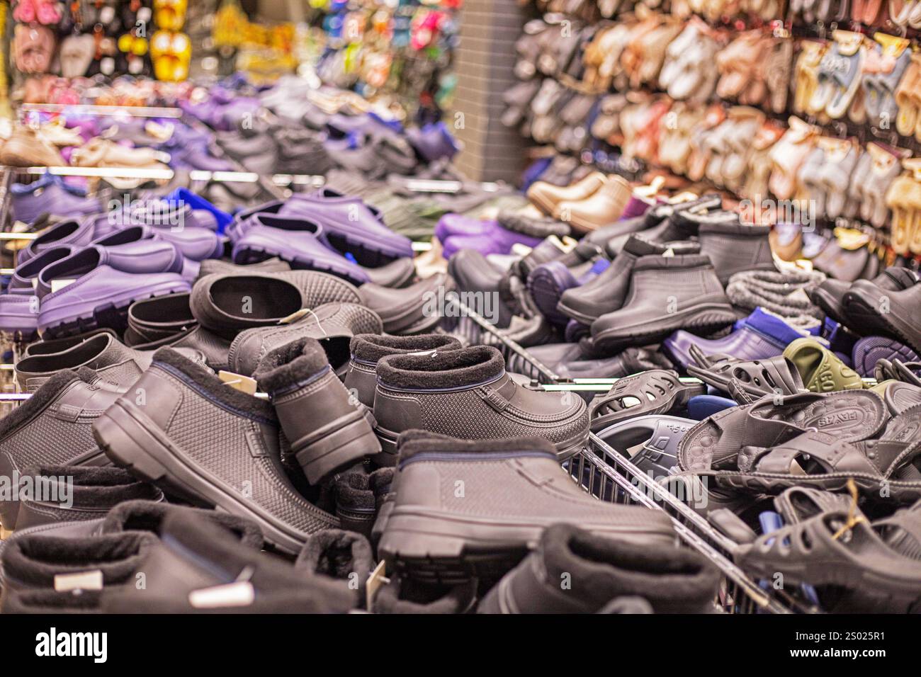 rubber galoshes and crocs in a container in a supermarket Stock Photo ...