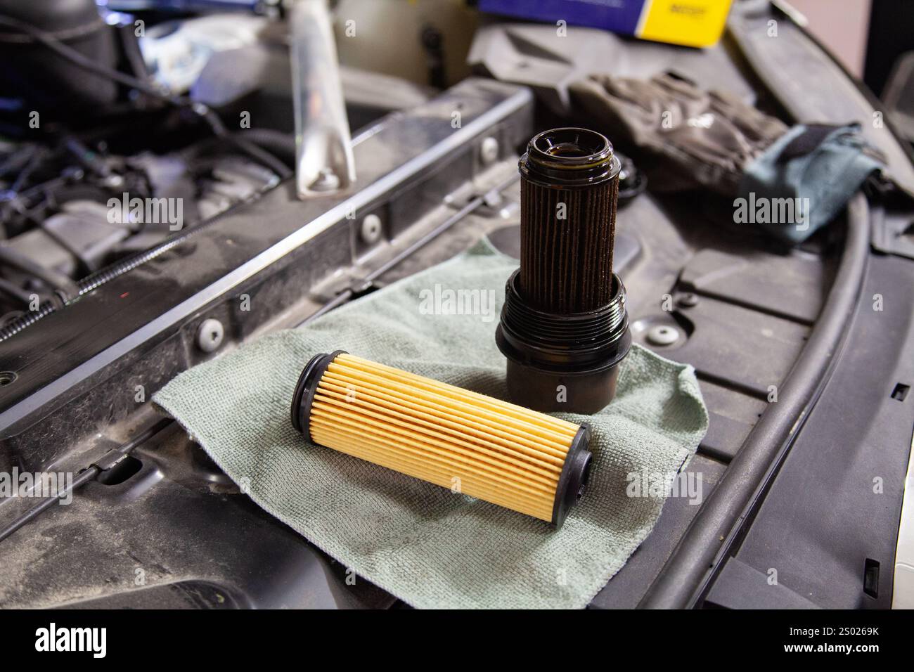 Replacing the old oil filter with a new one Stock Photo - Alamy