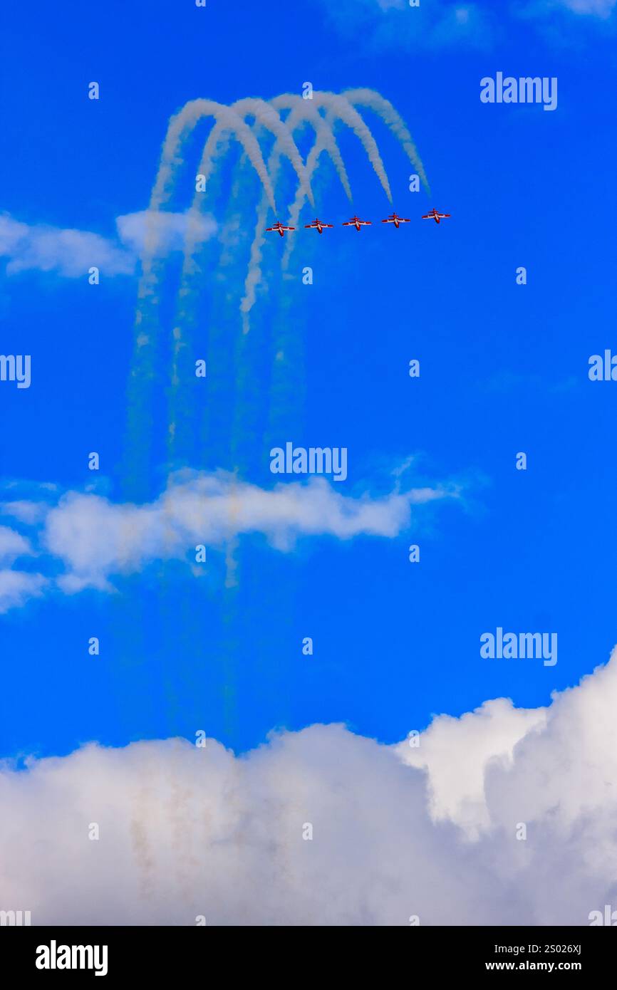 A group of fighter jets are flying in formation in the sky. The sky is ...