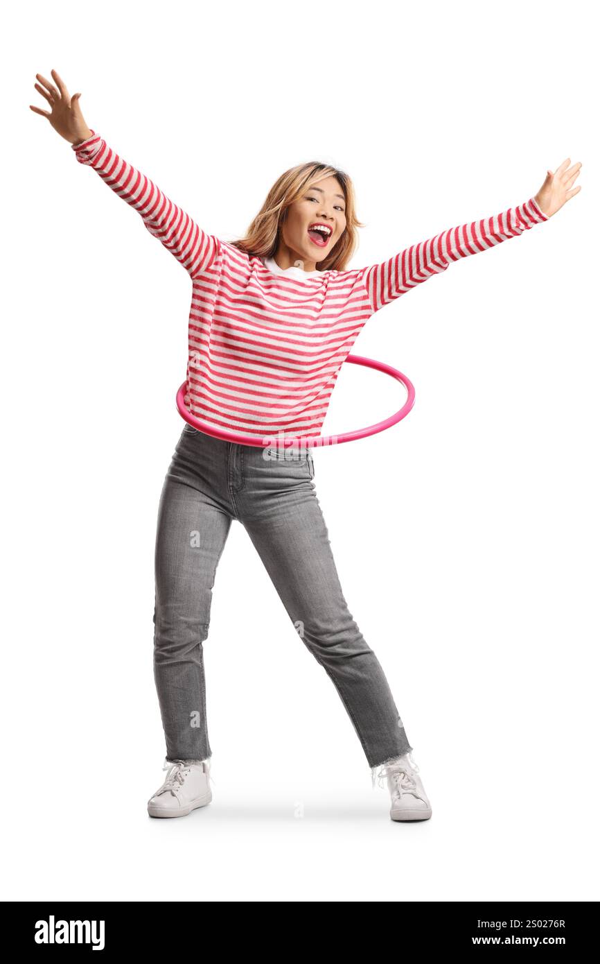 Cheeful asian woman spinning a hula hoop with hands up isolated on ...