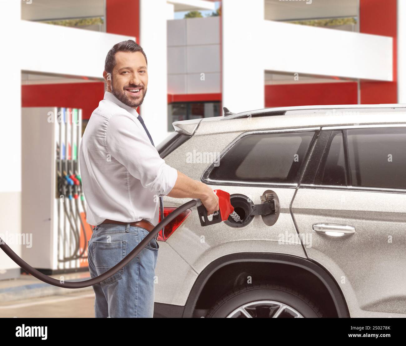 Man filling a car with petrol at a self service gas station Stock Photo ...