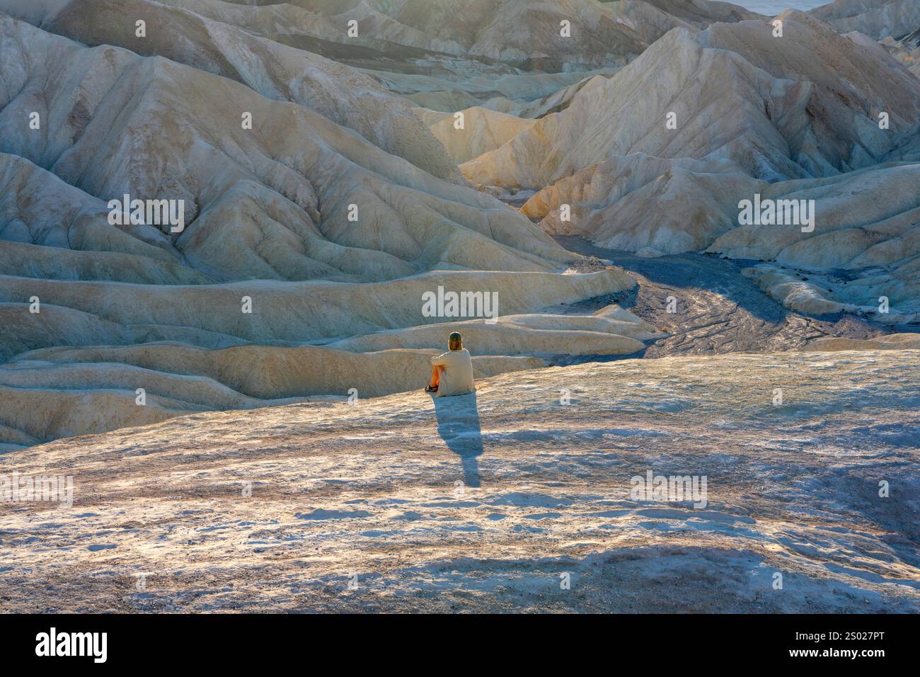 A woman takes in the sunset at Zabriski Point, Death Valley National ...