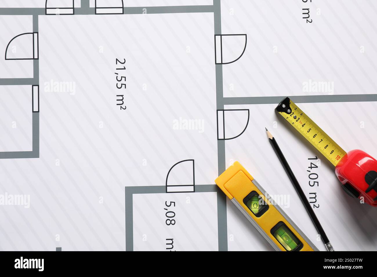 Pencil, measuring tape and building level on different architectural ...