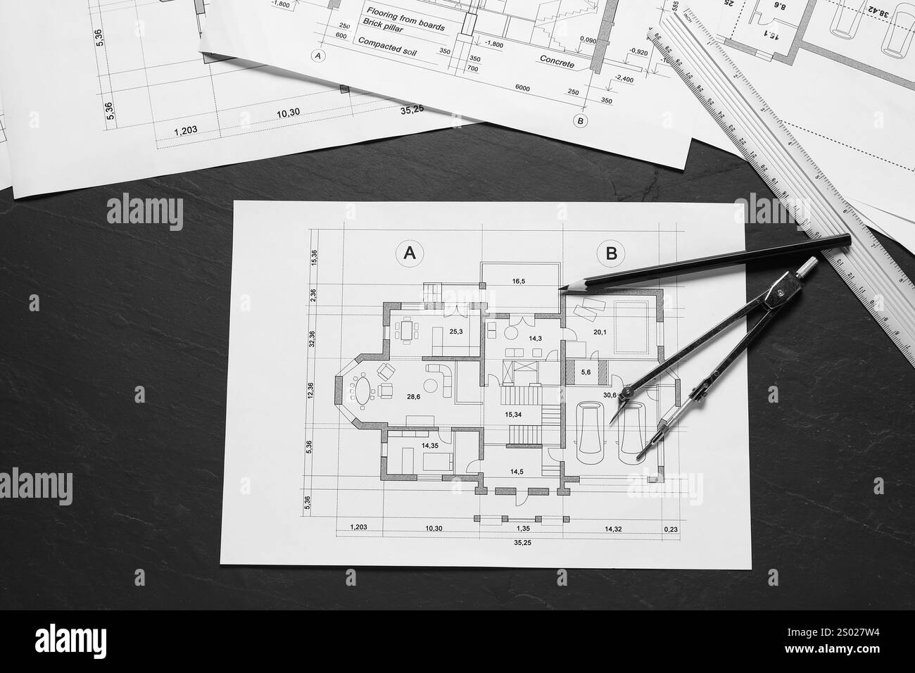 Different architectural drawings, ruler, divider and pencil on grey ...