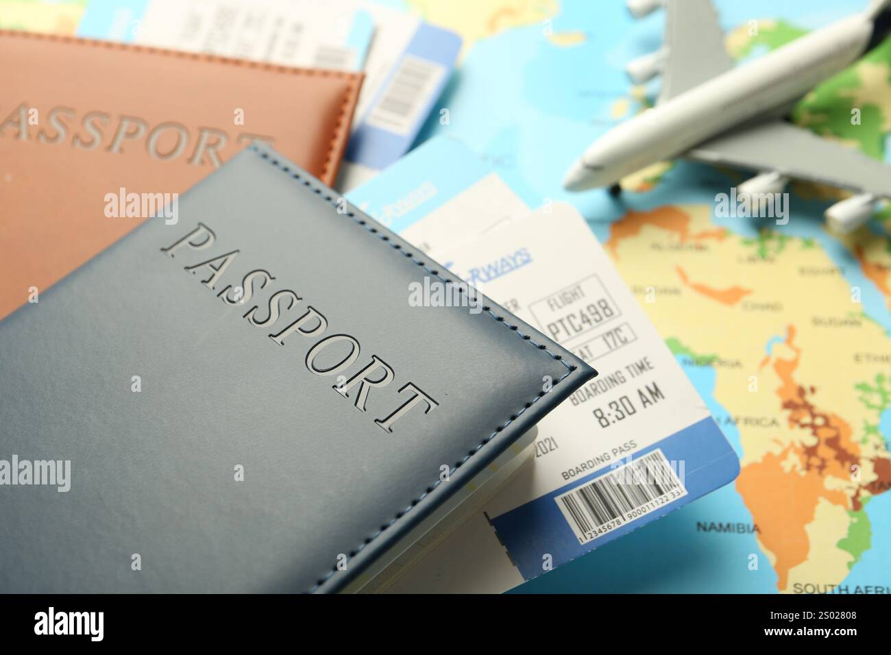 Passports with tickets and plane model on world map, closeup Stock ...