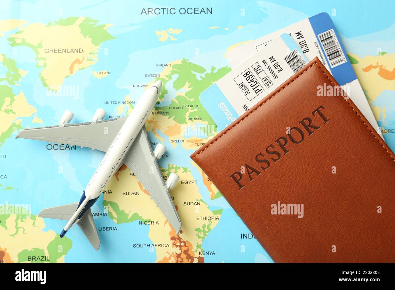 Passport with tickets and plane model on world map, top view Stock ...